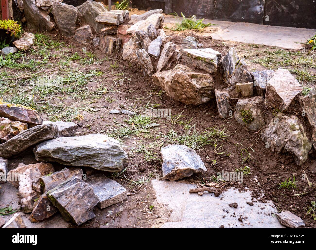 Natural stone wall is built with slate stones Stock Photo - Alamy
