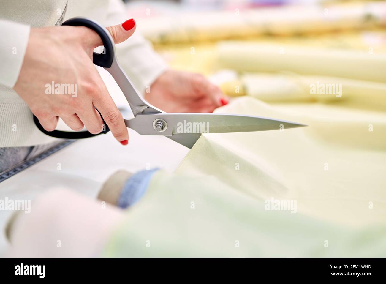 Tailor cutting fabrics hi-res stock photography and images - Alamy