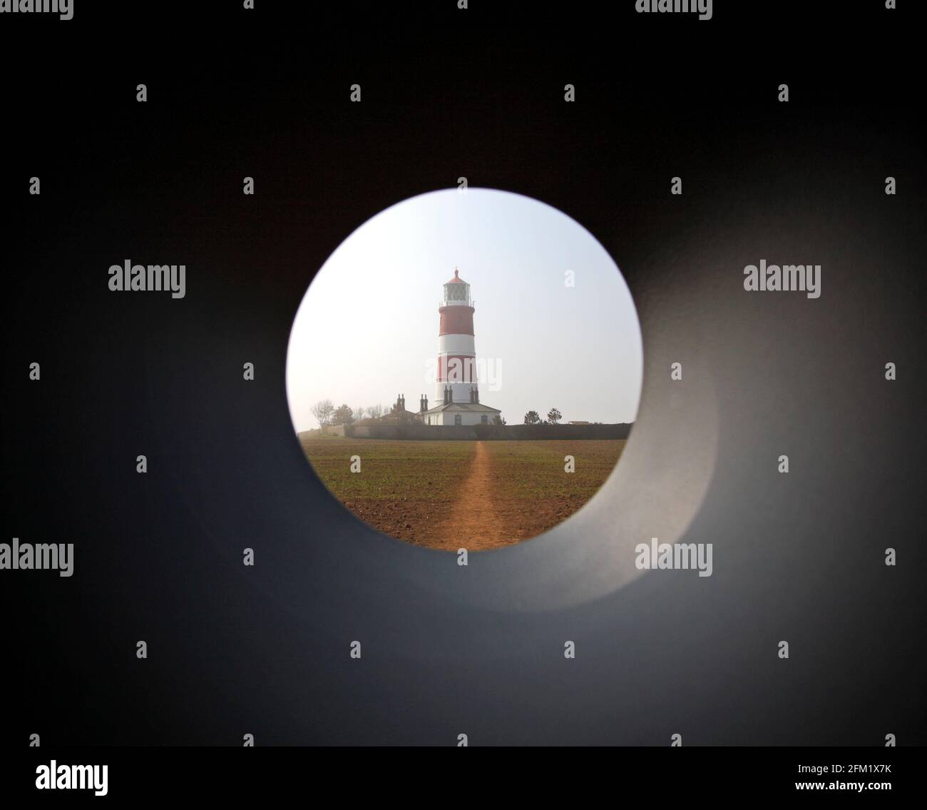 A creative view of Happisburgh Lighthouse seen through a lighting tube ...