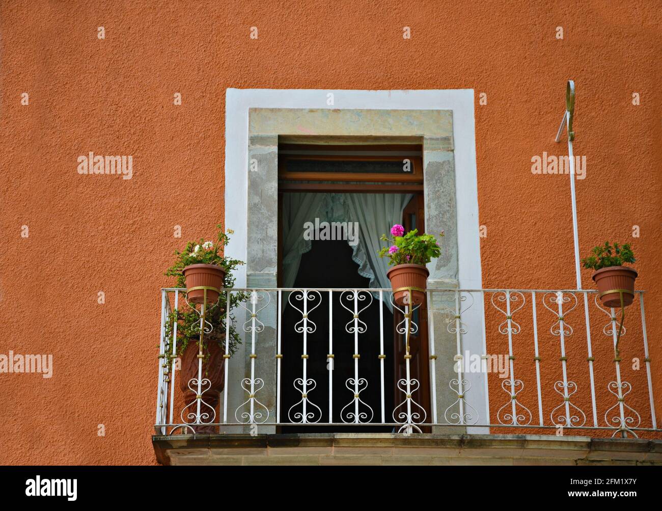 Spanish Colonial building facade with a Venetian ochre stucco wall, a ...