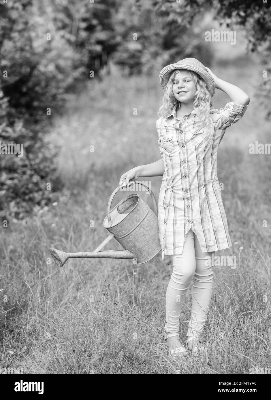 Spring gardening checklist. Watering plants in garden. Watering tools ...