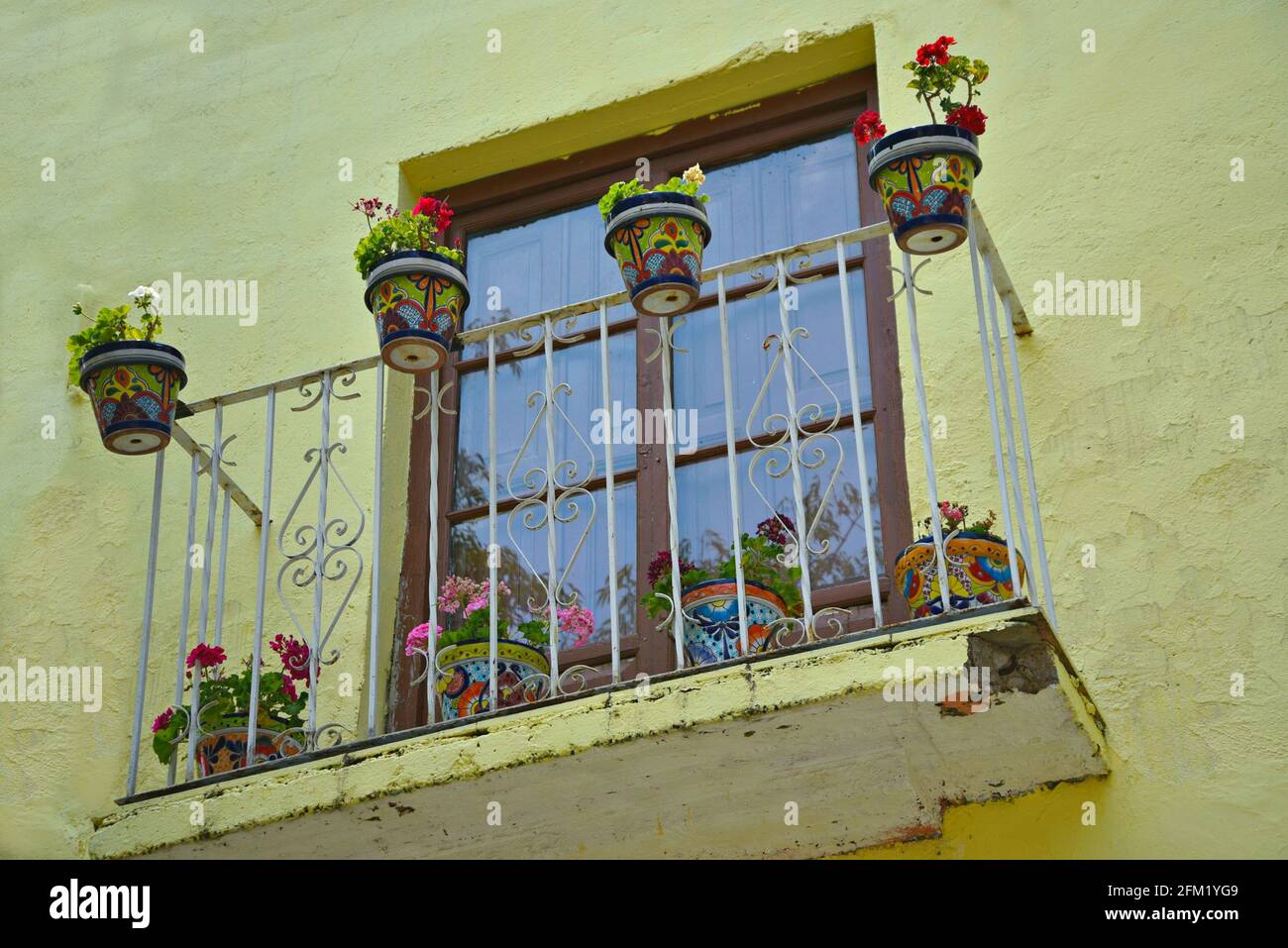 Spanish Colonial house with a Venetian lime stucco wall, stone trimmed ...
