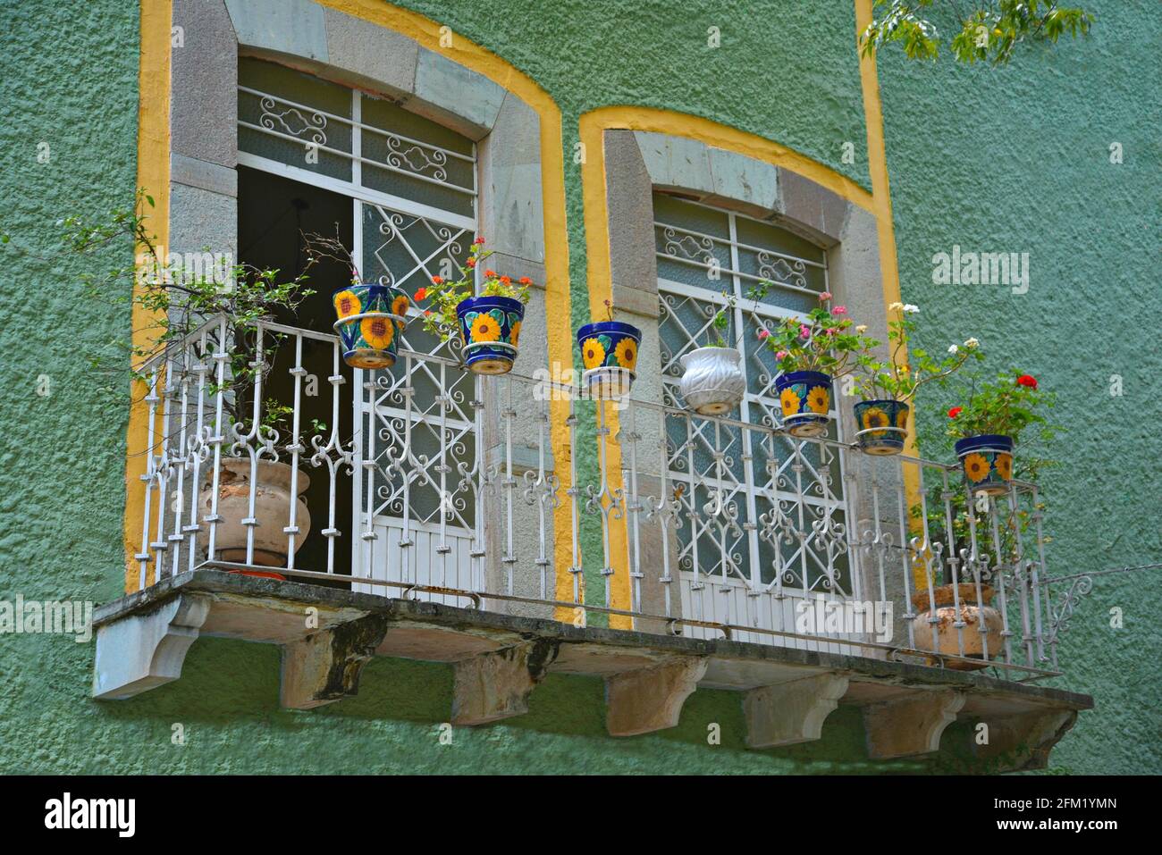 Spanish Colonial house with a Venetian stucco wall, stone trimmed ...