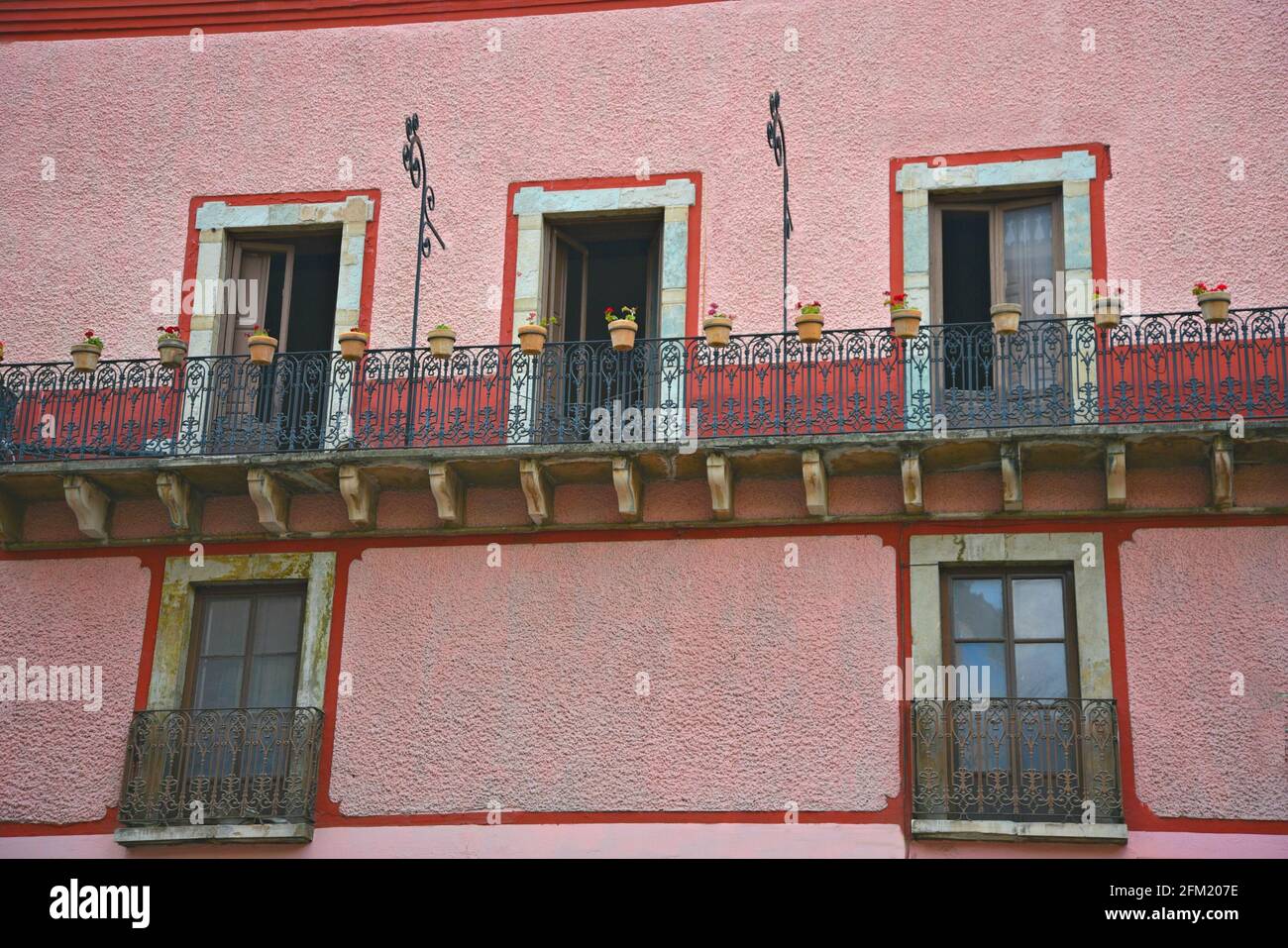 Spanish Colonial building with a Venetian stucco wall, stone trimmed ...
