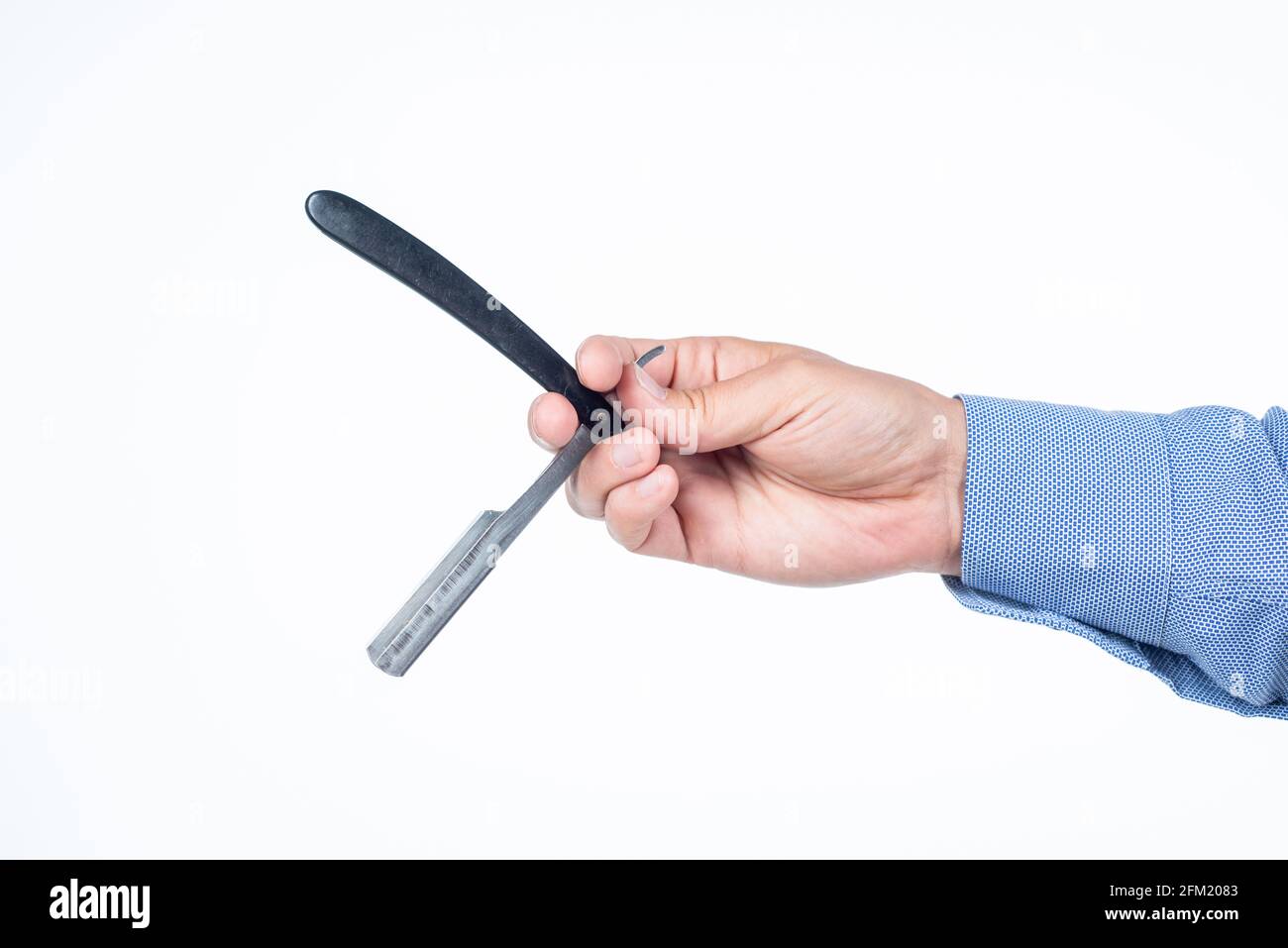 retro razor blade in hand of man isolated on white. hairdresser concept ...