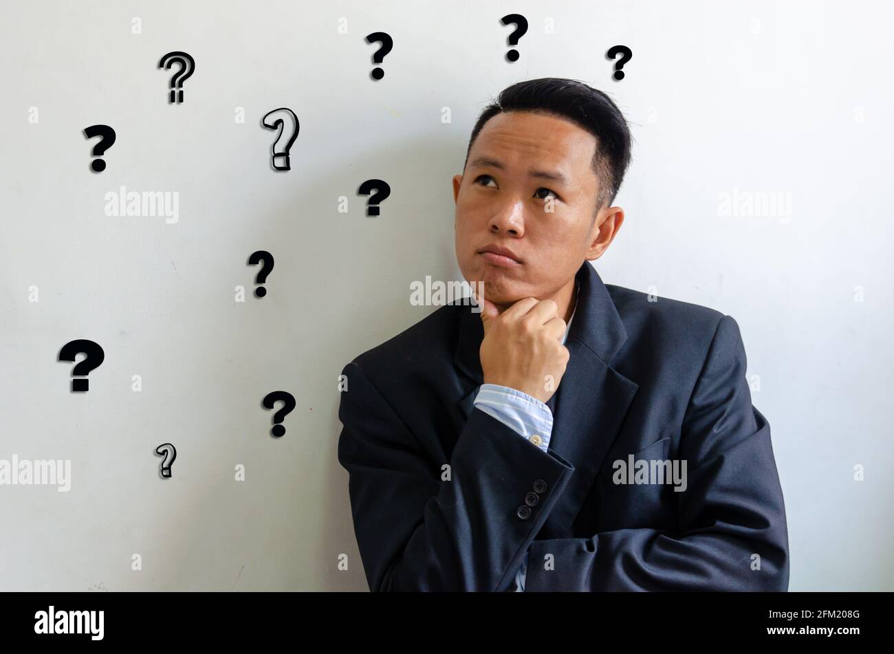 Asian businessman with a question mark.Concept business Stock Photo - Alamy