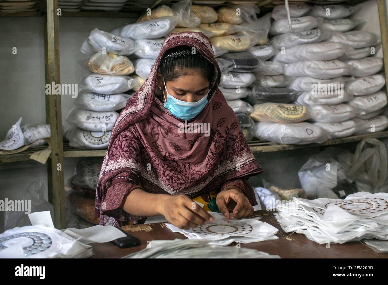 Dhaka, Bangladesh. 05th May, 2021. A worker wearing a face mask is seen ...