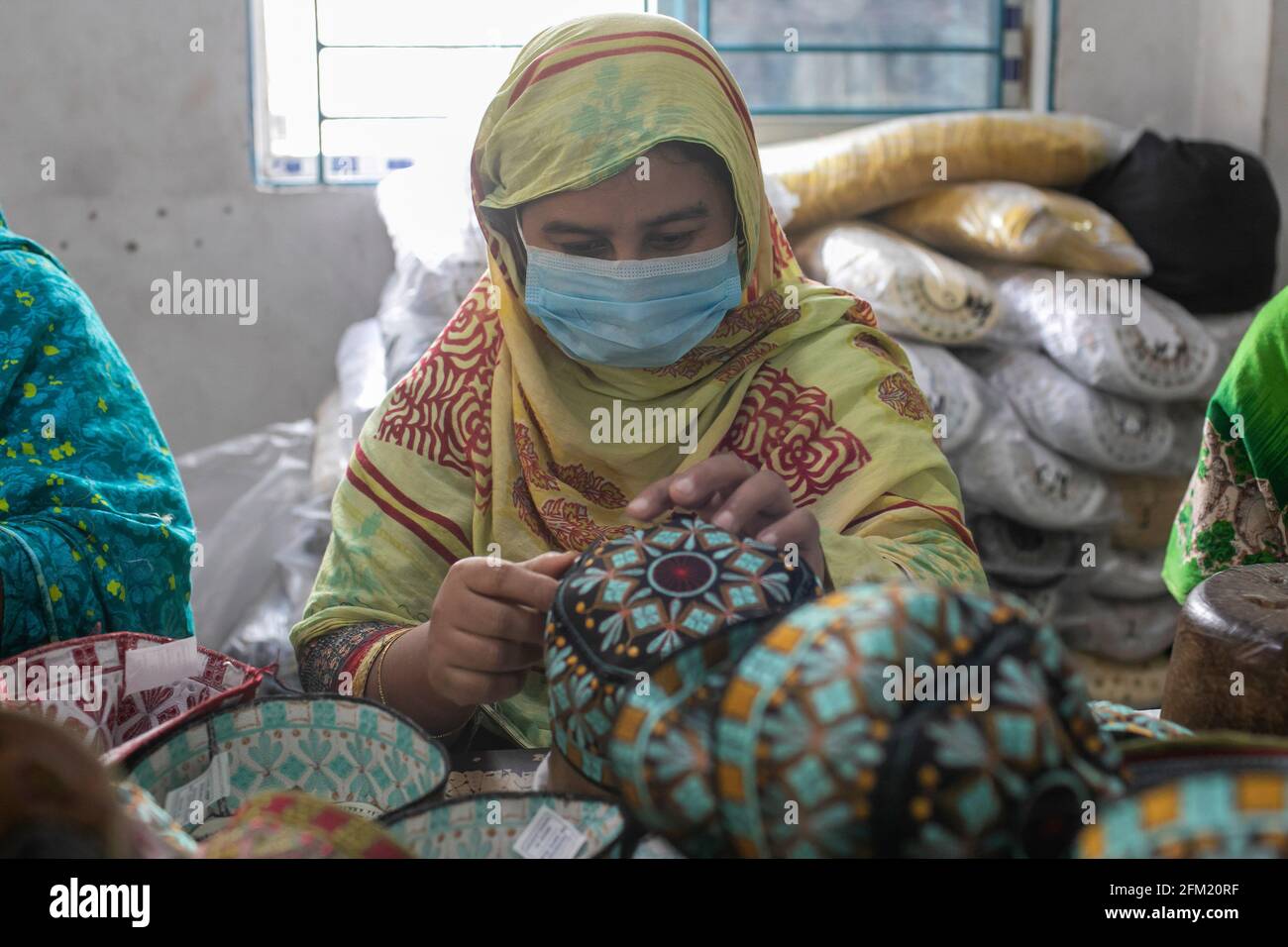Dhaka, Bangladesh. 05th May, 2021. A worker wearing a face mask is seen ...