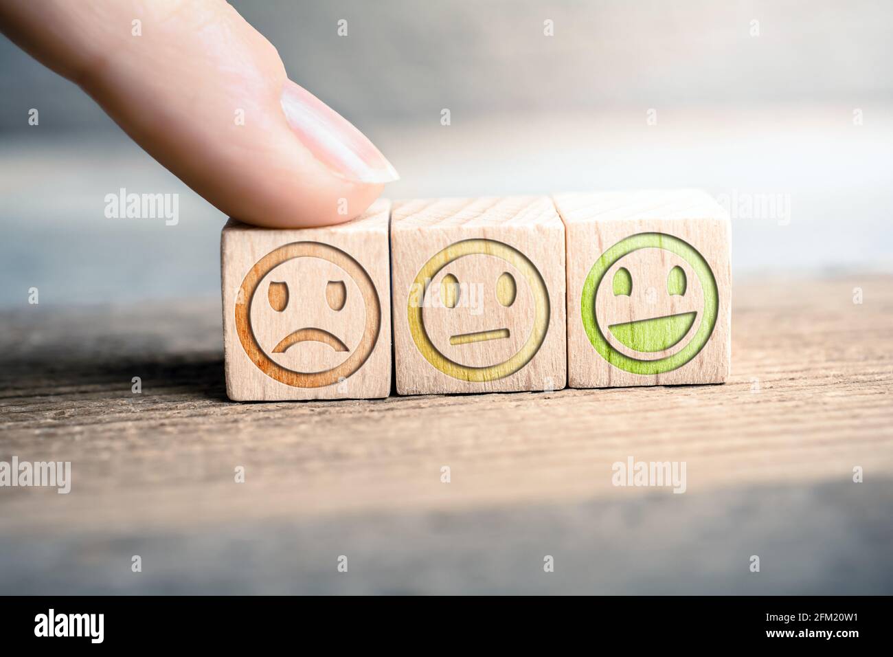 Bad Feedback Concept With Red, Yellow And Green Smiling Faces On Blocks ...