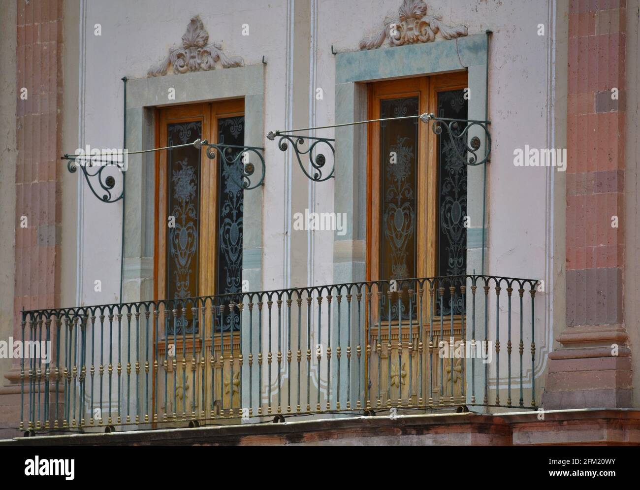Spanish Colonial building facade with a stucco wall, stone trimmed ...