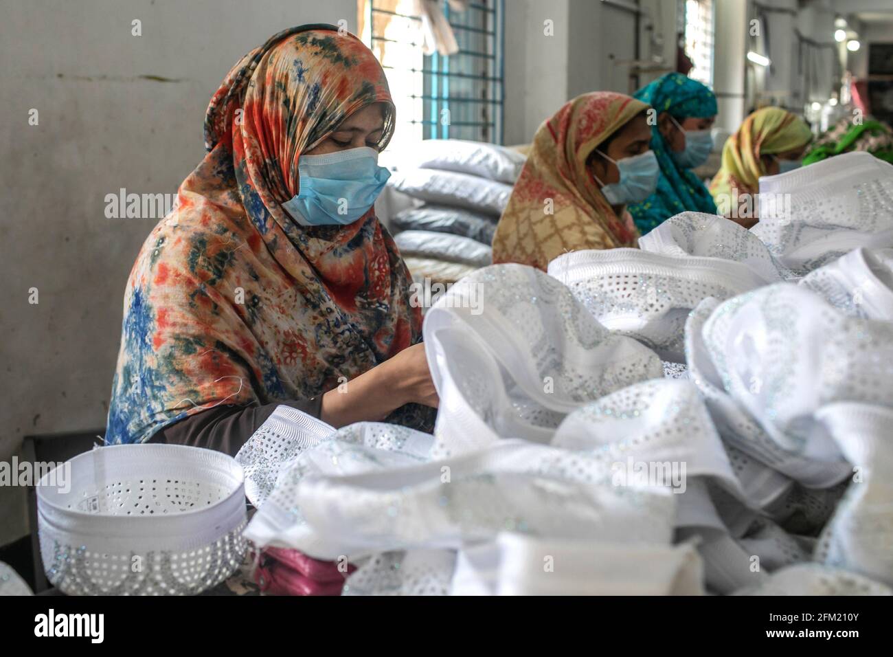 Dhaka, Bangladesh. 05th May, 2021. Workers wearing face masks are seen ...