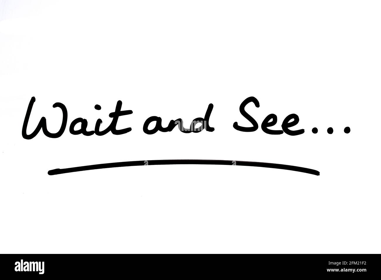 Wait and See… handwritten on a white background Stock Photo - Alamy
