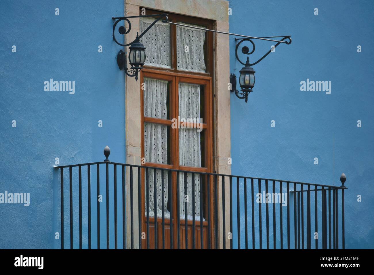Spanish Colonial house facade with a light blue Venetian stucco wall ...