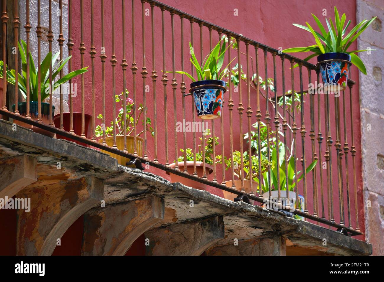 Spanish Colonial house facade with a Venetian red stucco wall and a ...