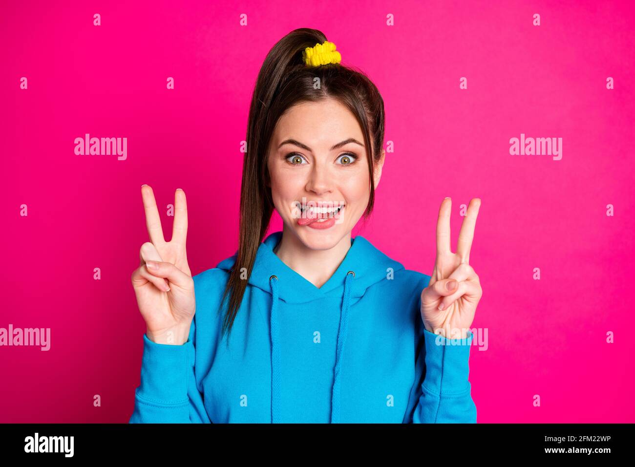 Photo Of Positive Lady Two Hands Fingers Show V Sign Tongue Out