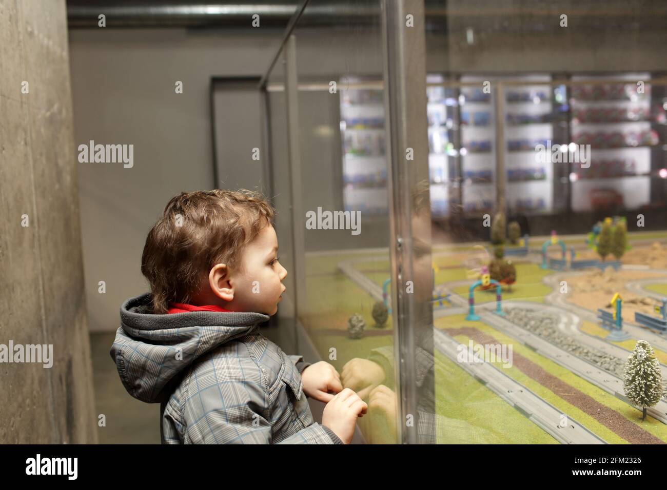 Child looking at toy city in the indoor playground Stock Photo - Alamy