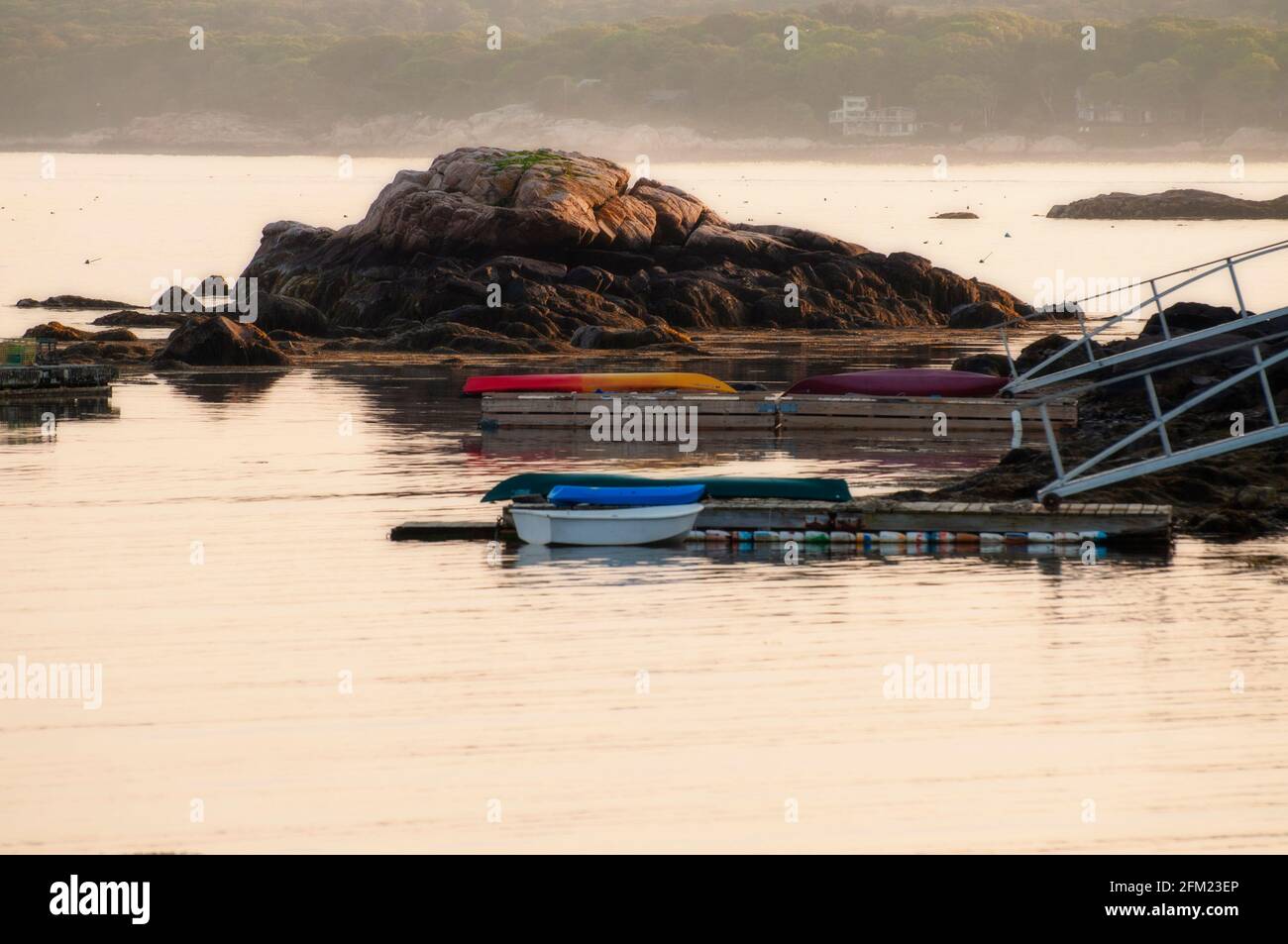 Boats and rocks and a dock are a classic scene Stock Photo - Alamy