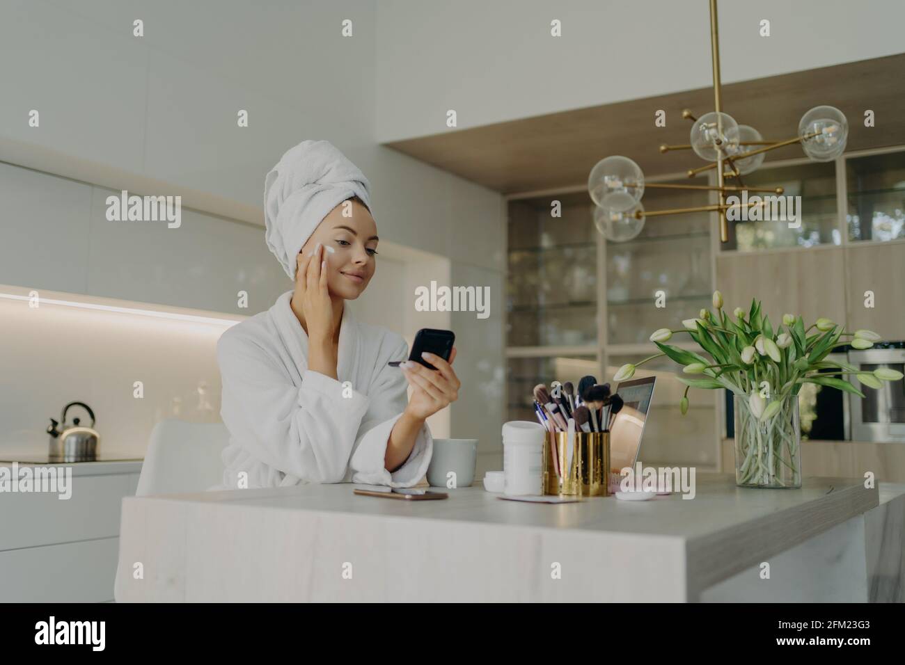 Happy healthy woman in bathrobe doing skincare daily routine after ...