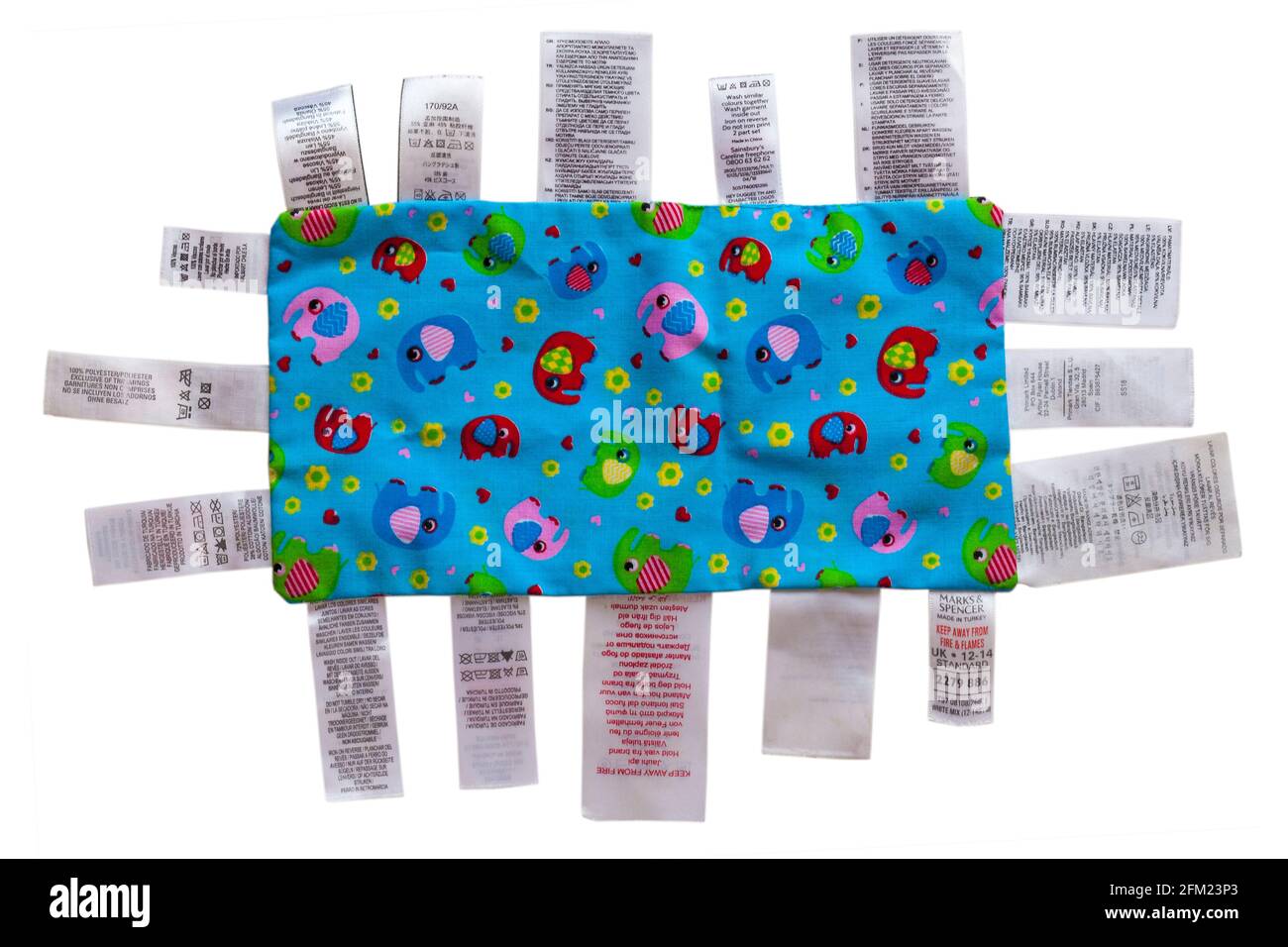 Various labels sewn around piece of fabric in many different languages ...