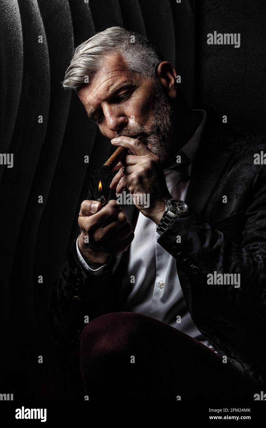 Portrait of a gentleman lighting a cigar Stock Photo - Alamy
