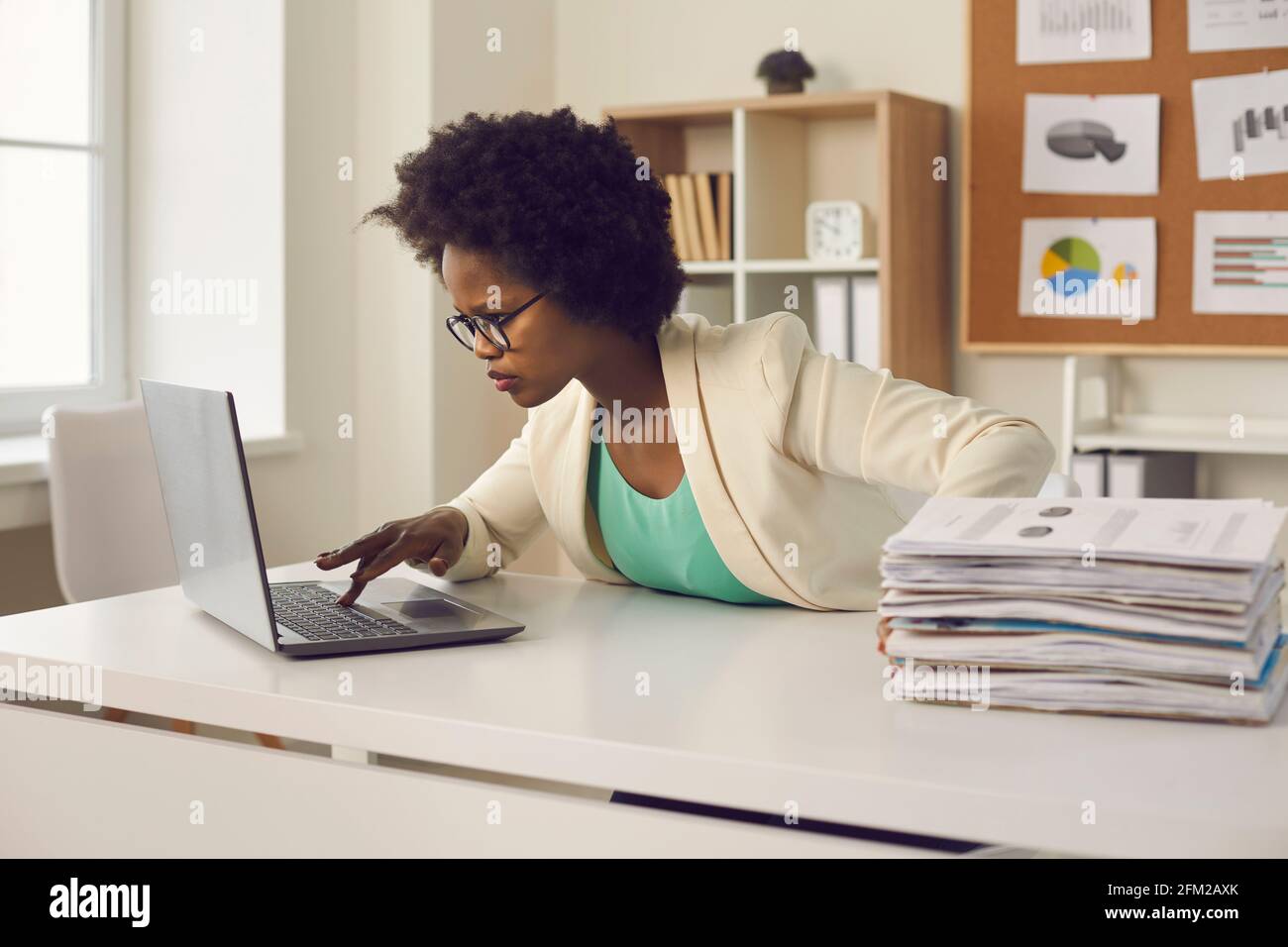 Business woman working with digital files on laptop instead of dealing ...