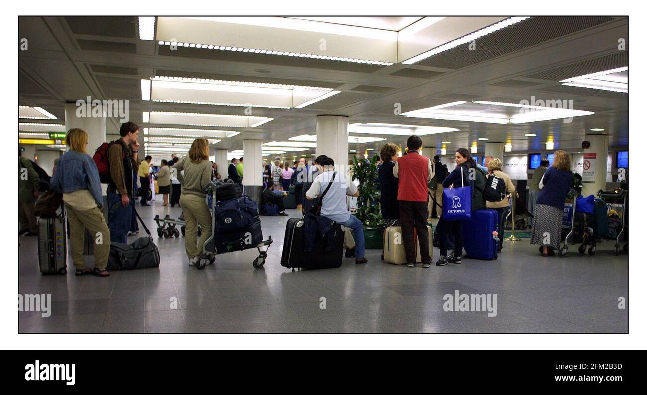 Travelers queue at Heathrow airport....for poss use with 25% decrease ...