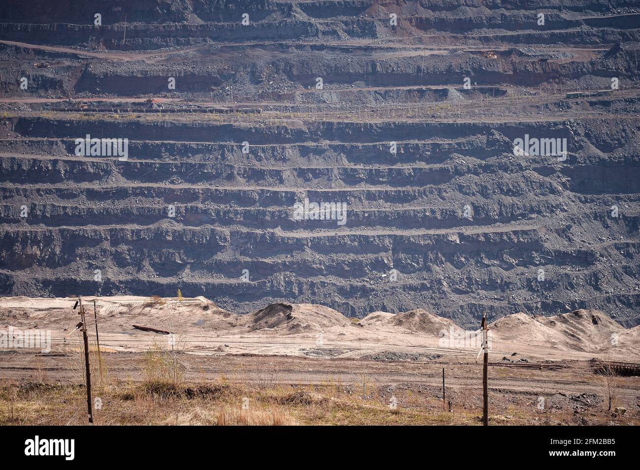 View of a part of an iron ore quarry with a railway train with terraces ...