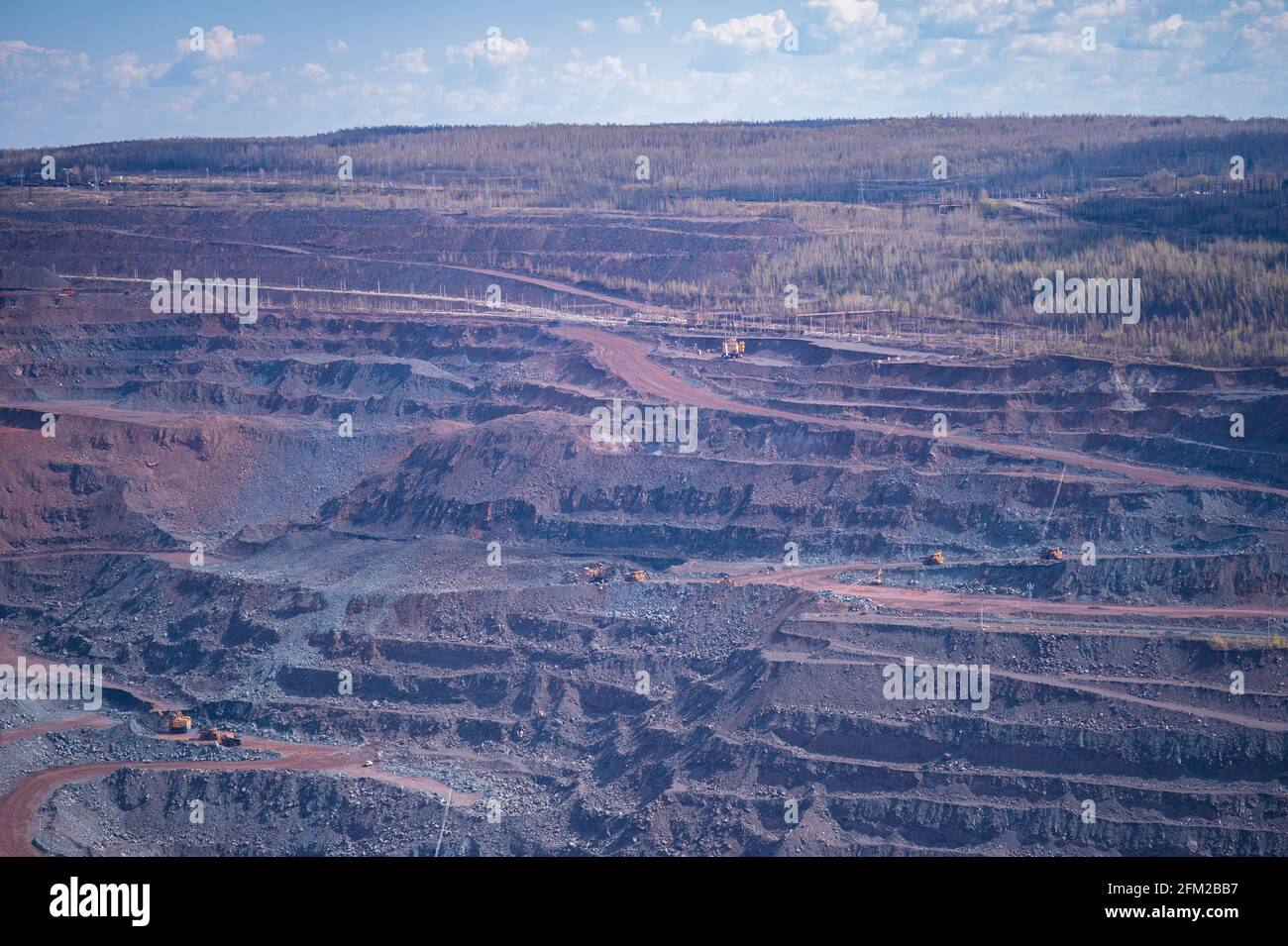View of a part of an iron ore quarry with various shades of pink and ...