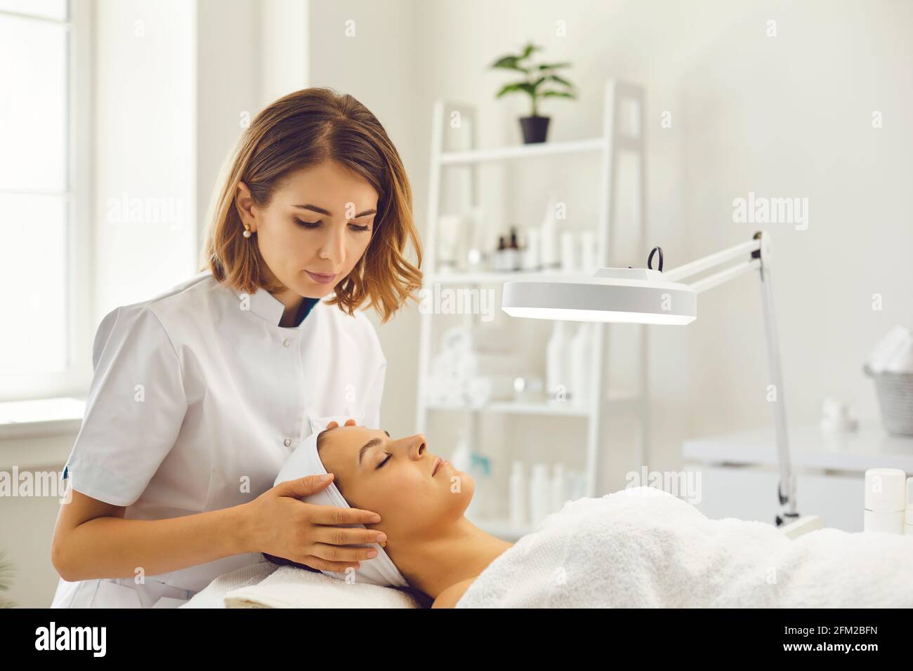 Beautician Makes A Light Facial Massage To A Young Girl To Improve The