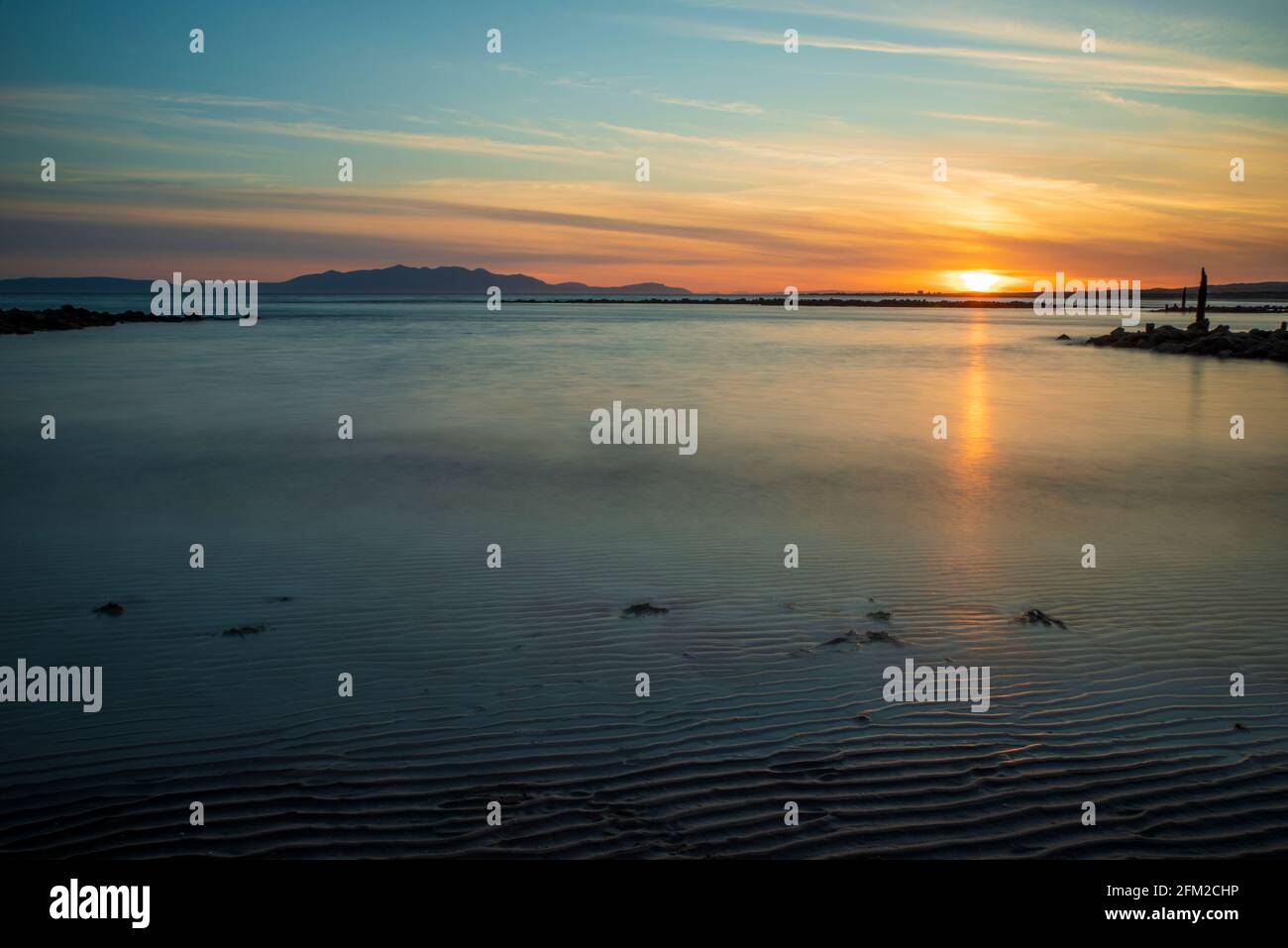 A beautiful sunset behind the Isle of Arran viewed from Irvine in North ...