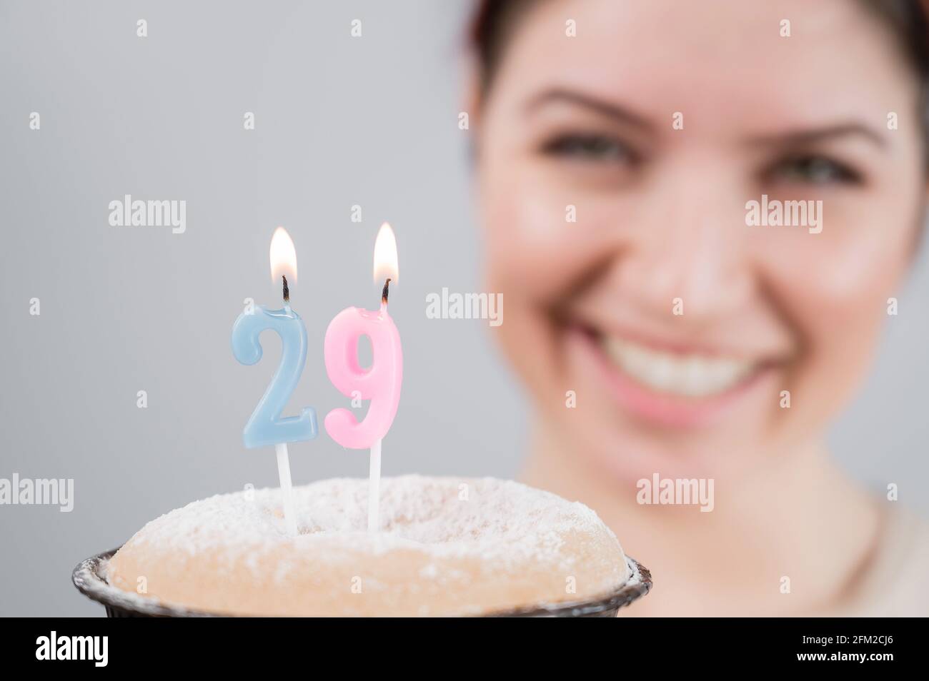 The Happy Woman Makes A Wish And Blows Out The Candles On The 29th