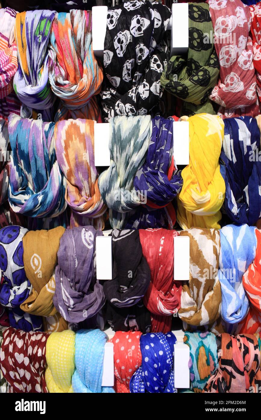 These are bright scarves in the department store Stock Photo - Alamy