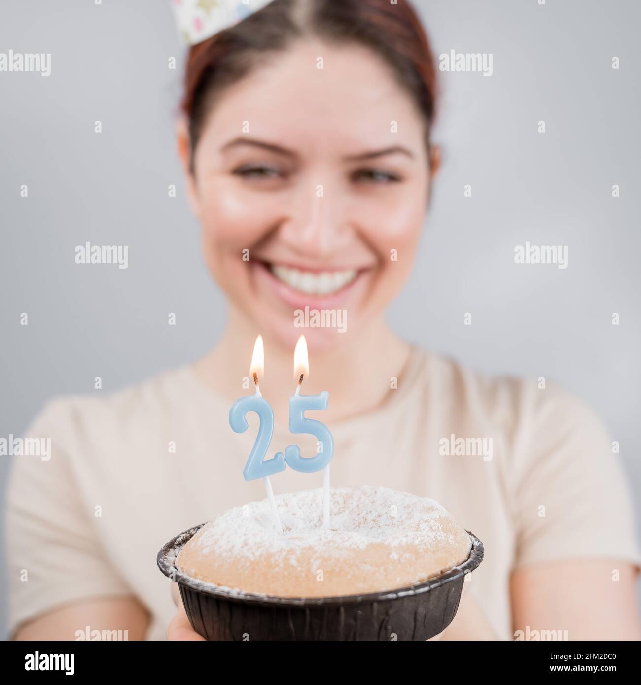 The Happy Woman Makes A Wish And Blows Out The Candles On The 25th