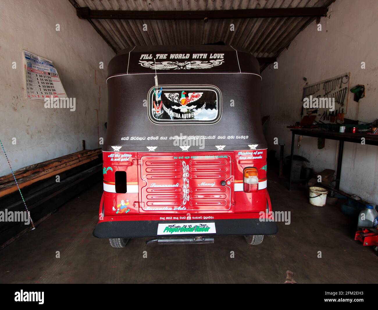 The back end of a red tuk tuk, rickshaw in a garage in Sri Lanka Stock ...