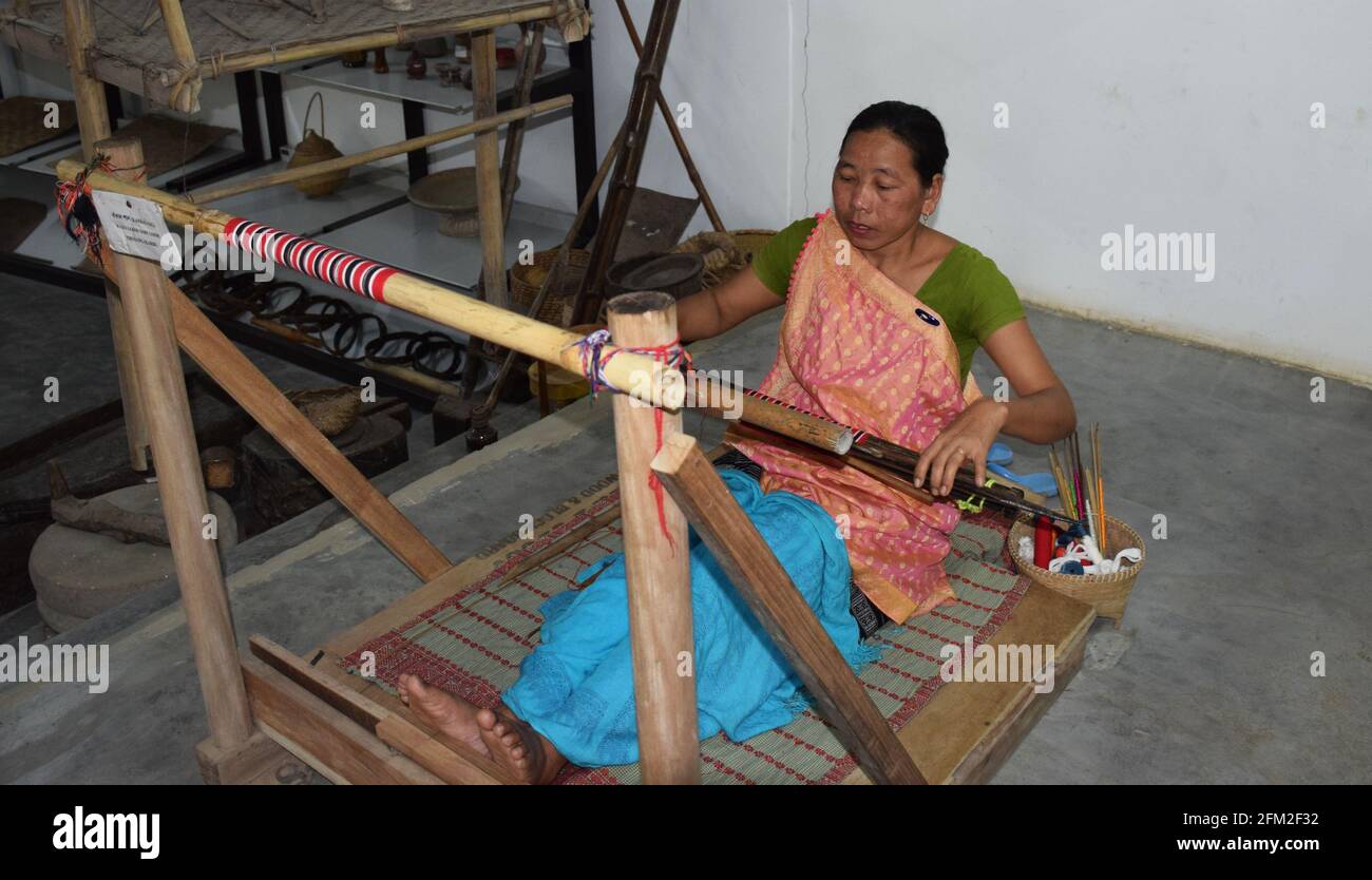Indian Assamese woman weaver uses a loom to make a hand woven saree at her workshop Stock Photo ...