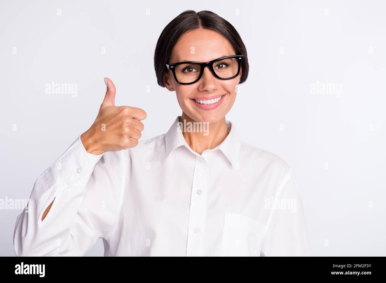 Photo Of Optimistic Brunette Hairdo Lady Show Thumb Up Wear Shirt