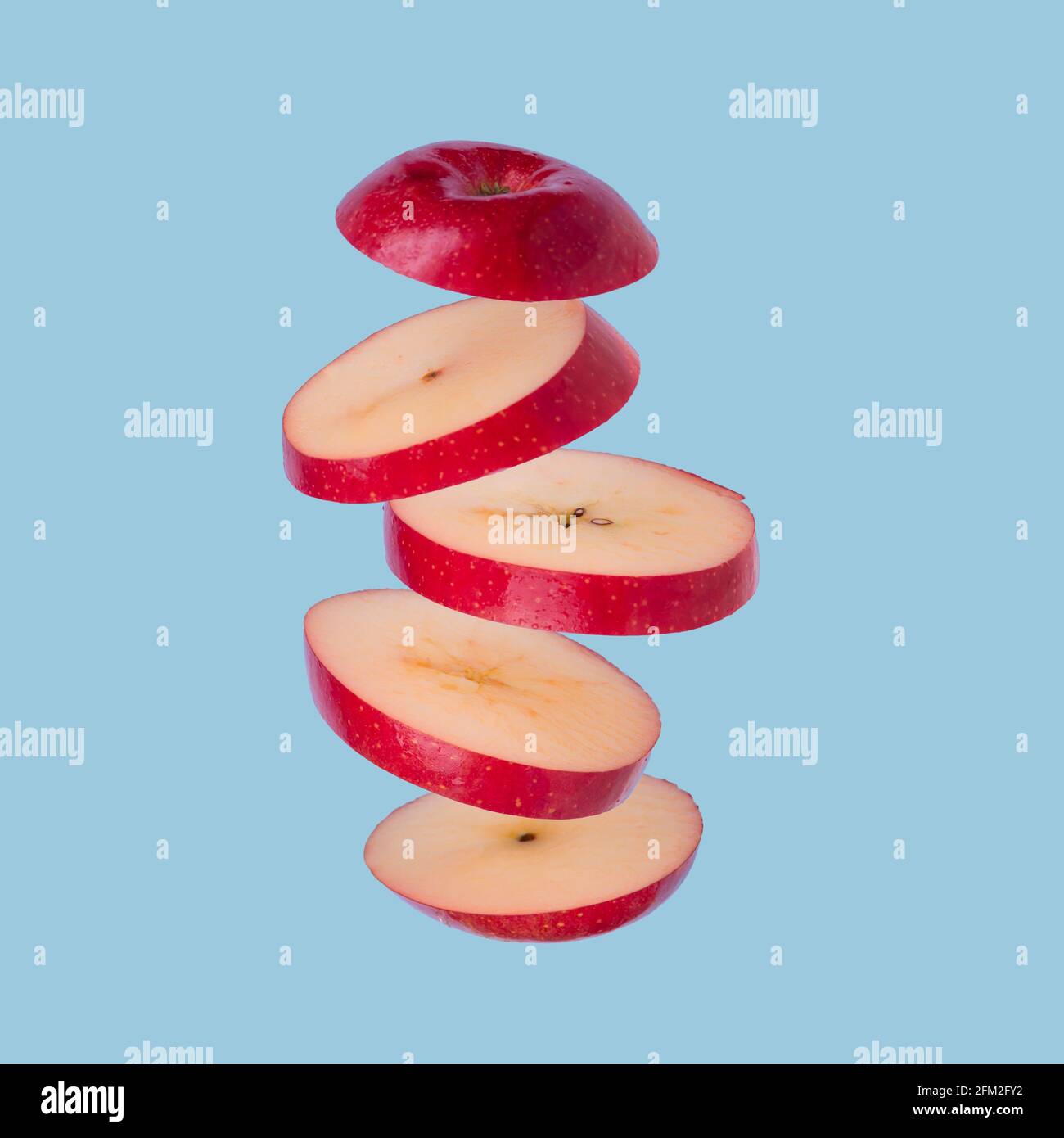 Floating levitating ripe apple on a blue background. Vitamins, healthy ...