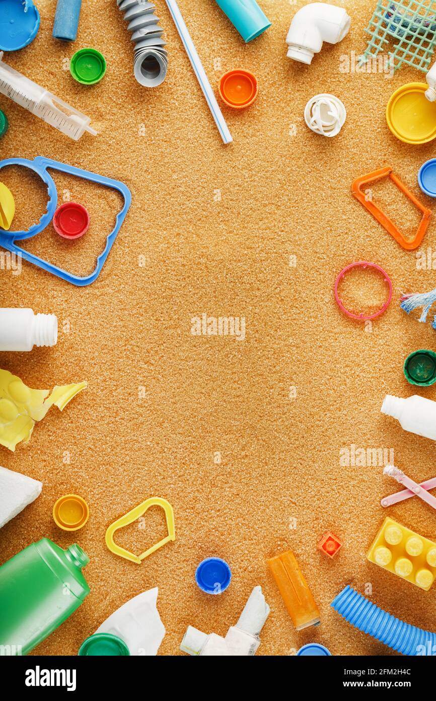 Garbage made of colorful plastic on an oceanic sandy beach. Global ...