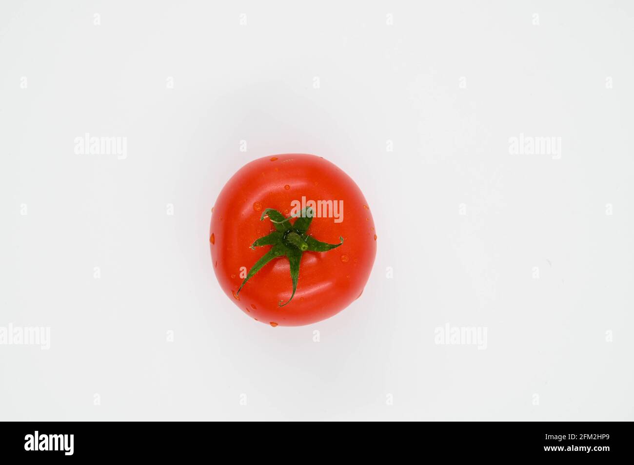 Tomato close-up from above with water drops on an isolated white ...