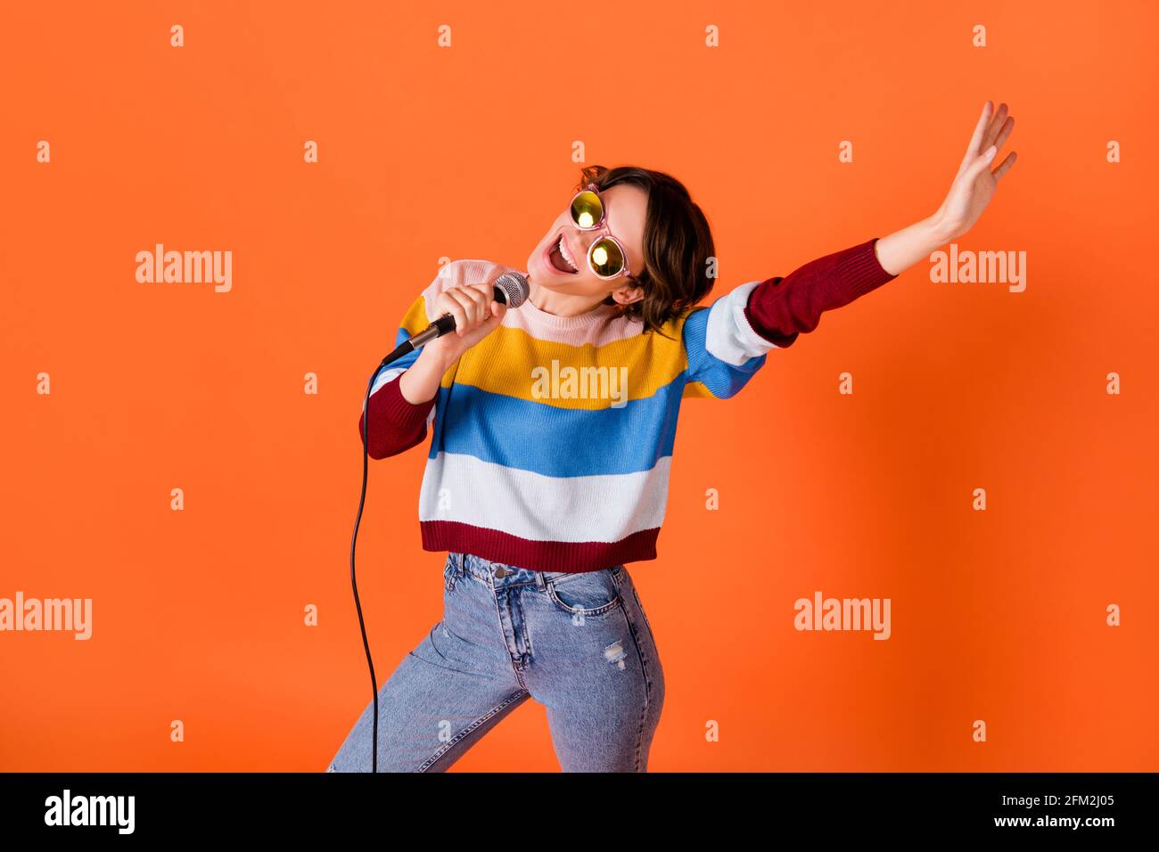 Photo of shiny funky young lady dressed striped pullover dark eyewear ...