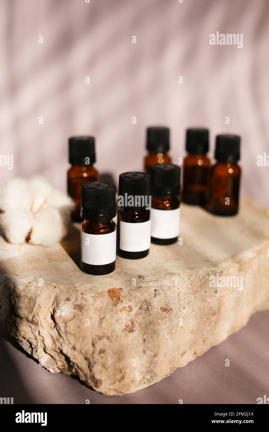 different cosmetics products on rock, Essential oils or face toner ...