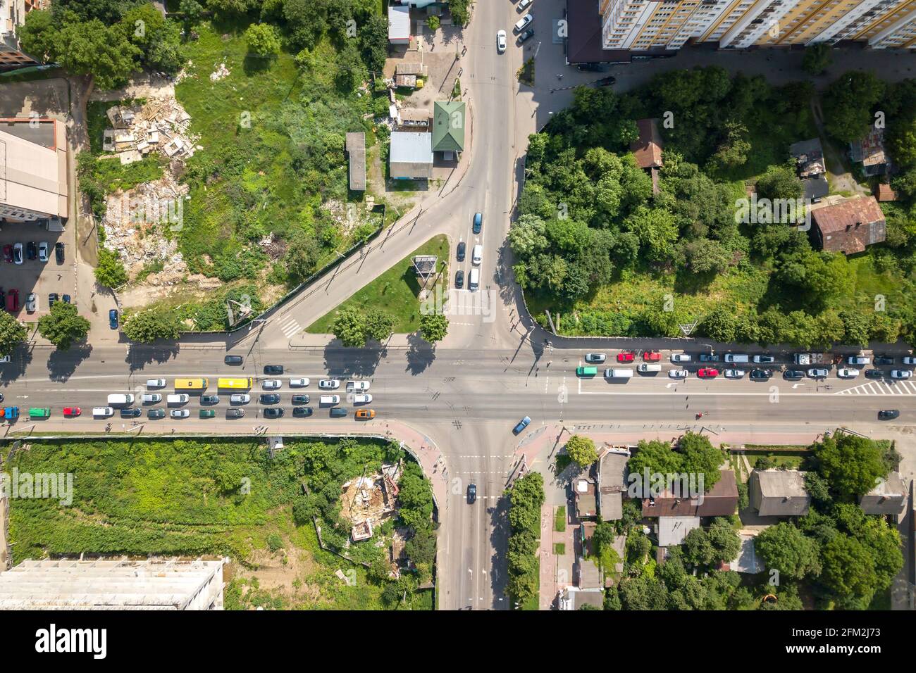 Top down aerial view of busy street intersection with moving cars ...