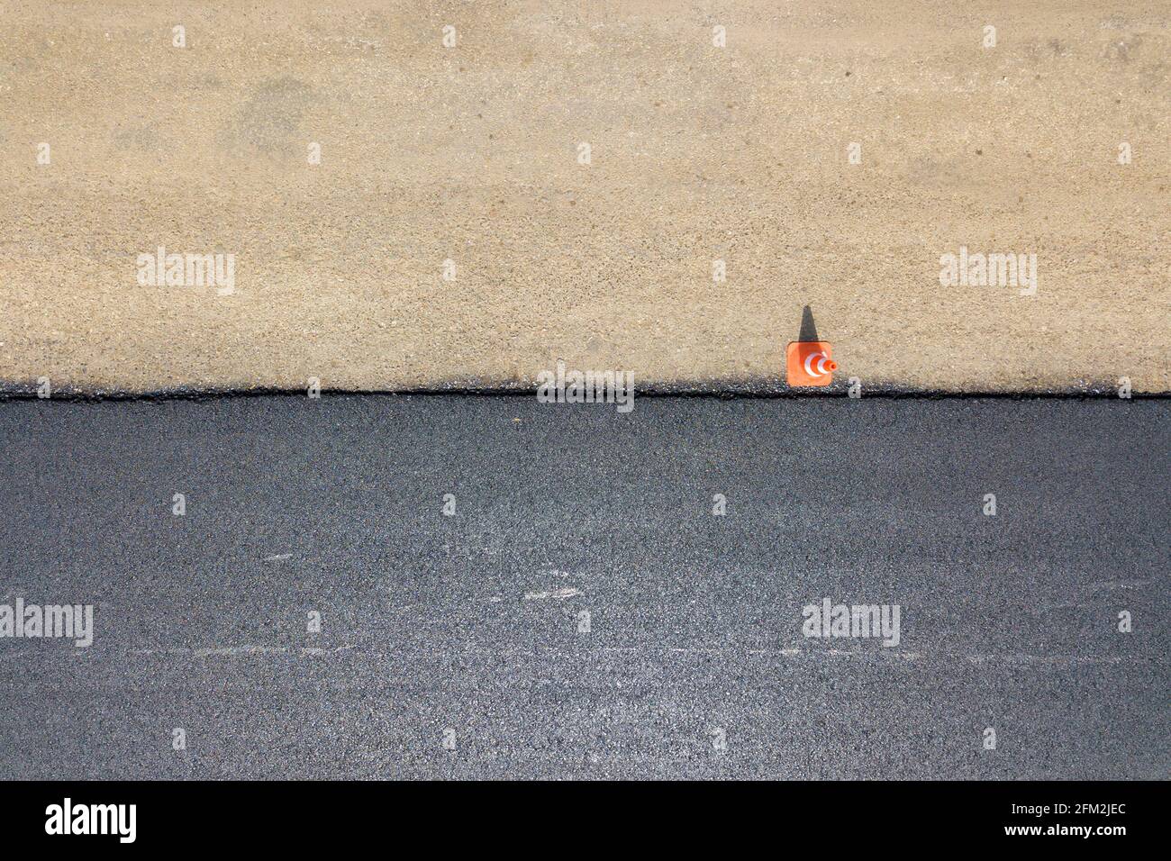 Aerial view of new road construction with newly layed black asphalt ...