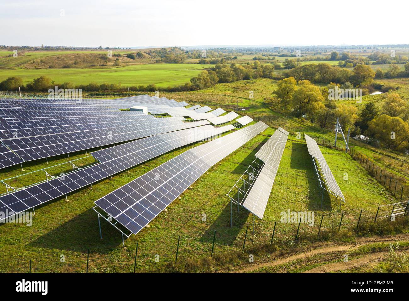 Aerial view of solar power plant under construction on green field ...