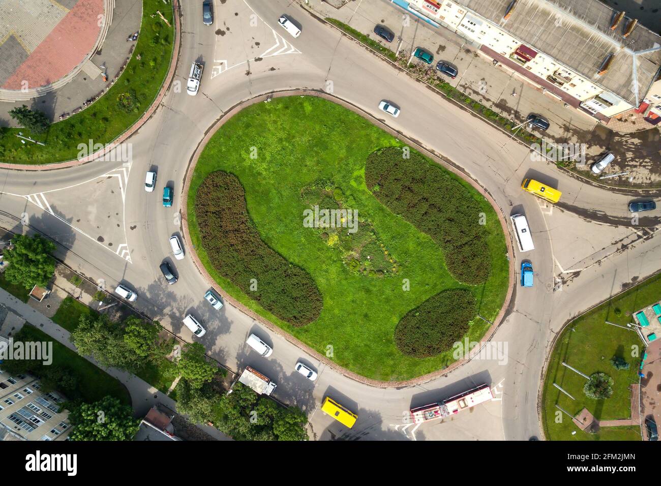 Top down aerial view of busy street roundabout intersection with moving cars traffic Stock Photo ...