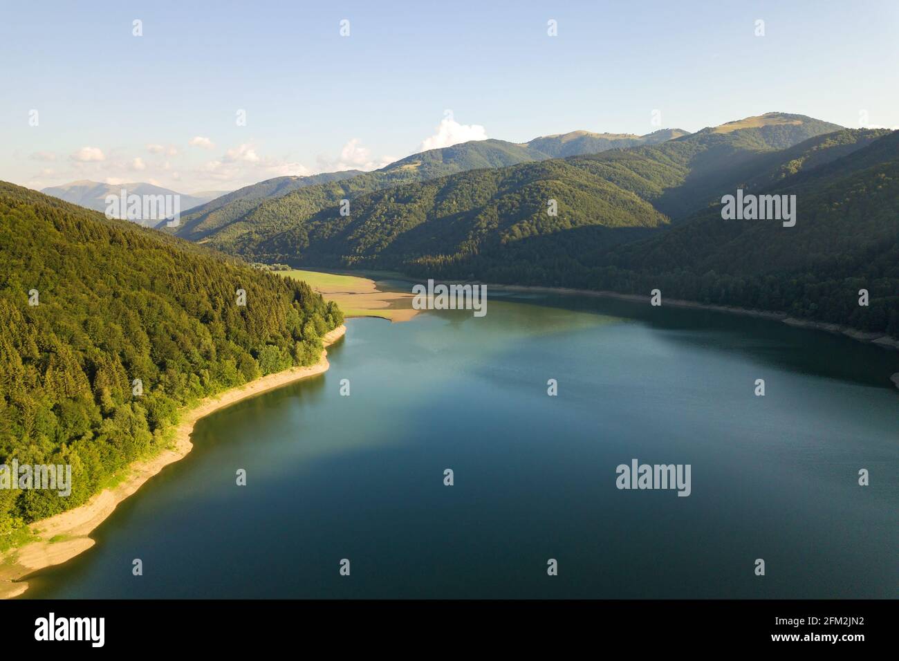 Aerial view of big lake with clear blue water between high mountain ...