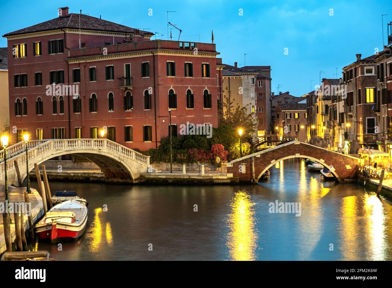 Night view of illuminated old architecture, floating boats and light ...