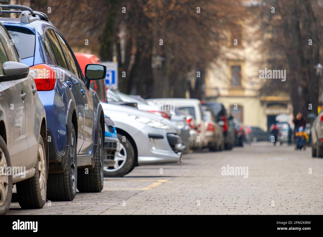 Cars parked in a row on a city street side Stock Photo - Alamy