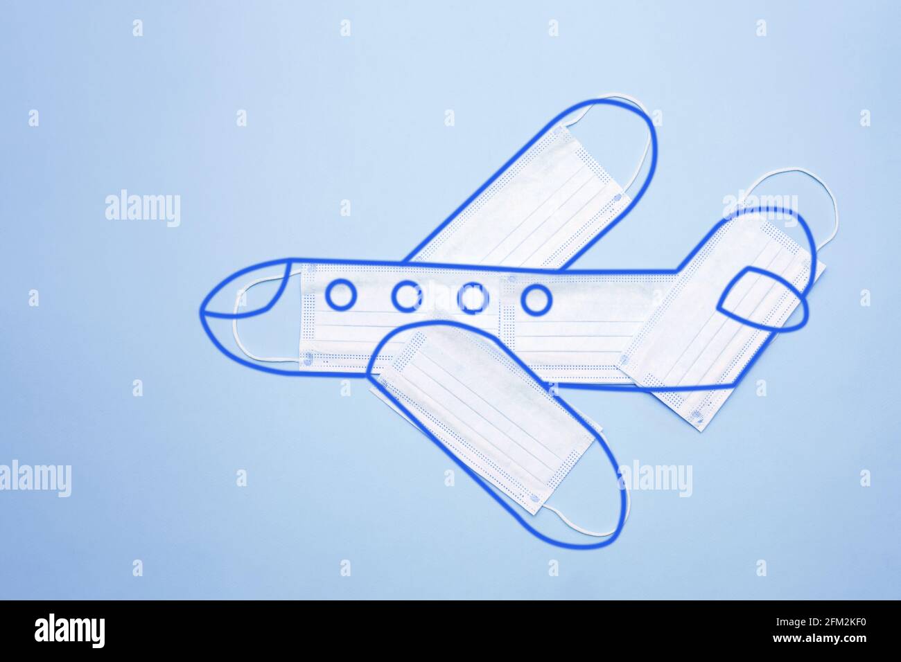 Airplane model made of protective masks with an outlined outline on a ...