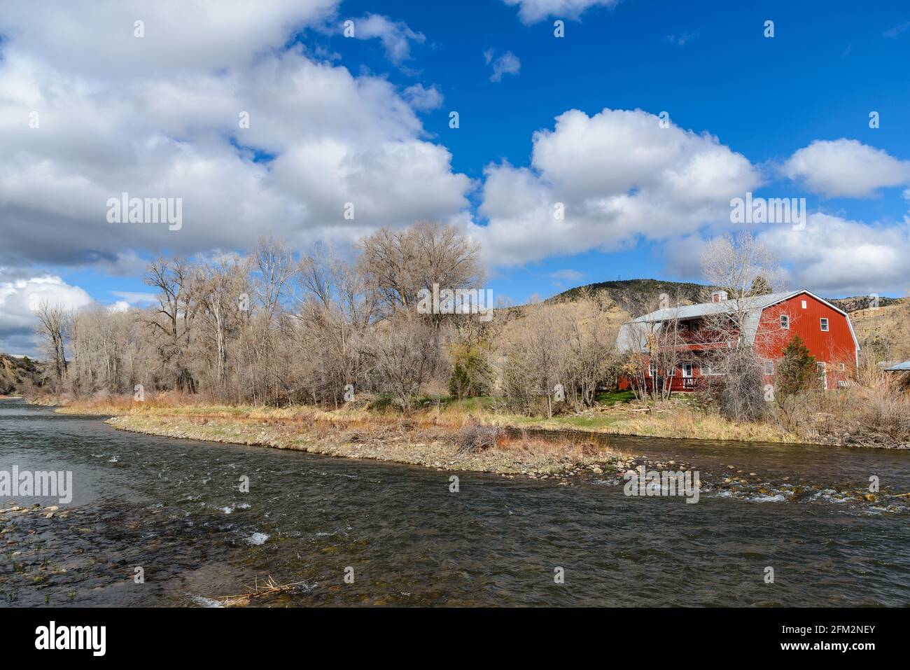 A red barn style house by a river. Colorado, USA Stock Photo - Alamy